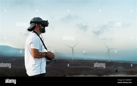 Drone Engineer Using First Person View Technology On The Turbine Farm