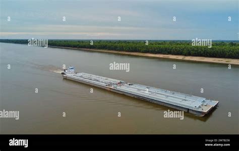 An Aerial View Of A Barge On The Mississippi River With A Blue Sky In