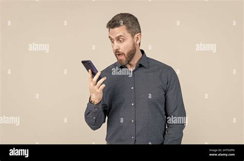Surprised Mature Man Businessman With Beard Looking On Phone Surprise Stock Photo Alamy