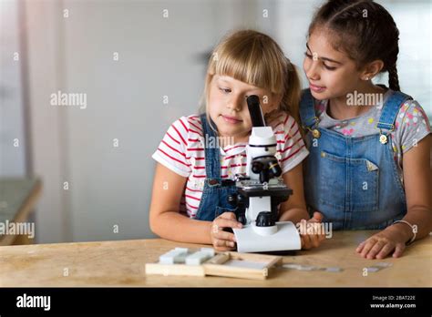 Girls With Microscope Stock Photo Alamy