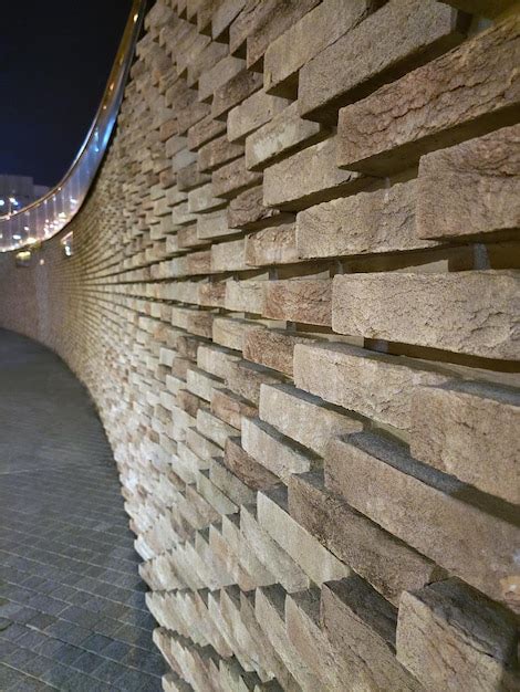 Premium Photo Decorative Long Brick Wall In Rounded Perspective The