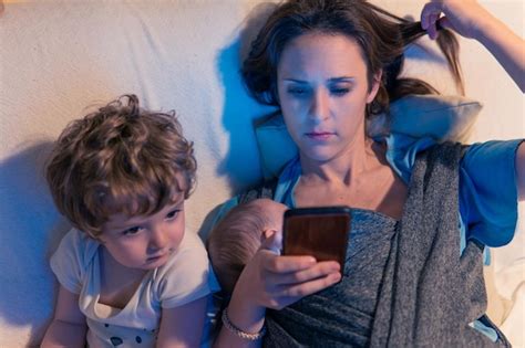 Premium Photo High Angle View Of Woman Using Mobile Phone While Lying On Bed At Home