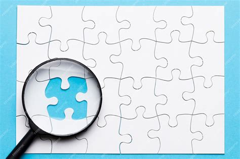 Premium Photo Close Up Of Magnifying Glass On Missing Puzzle Over Blue Background
