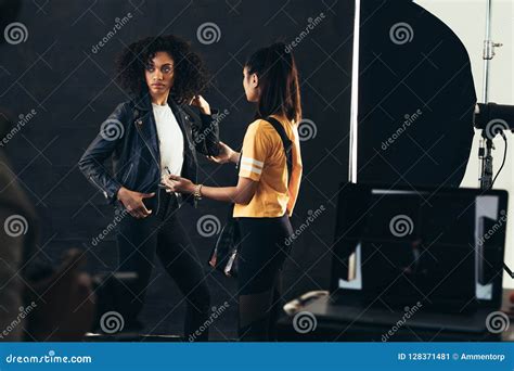 Stylist Adjusting Model During A Fashion Shoot Stock Image Image Of