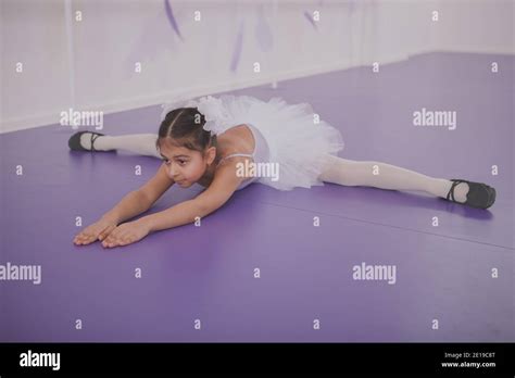 Adorable Little Ballerina Stretching Before Ballet Class At Dance School Cute Young Girl