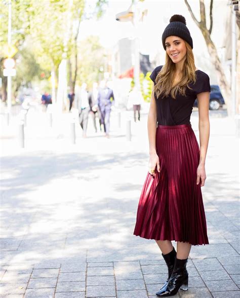A Burgundy Midi Skirt With A Black Bodysuit Boots And Beanie A Great