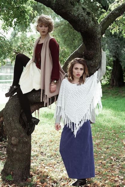 Premium Photo Two Young Beautiful Women Posing On A Tree