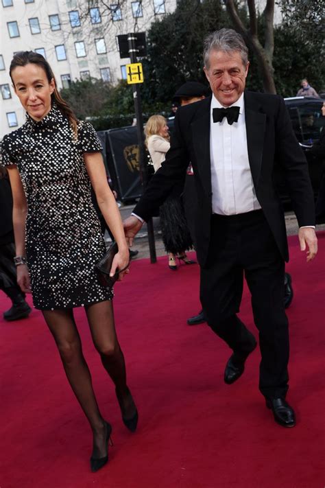 Hugh Grant Makes Rare Red Carpet Appearance With Leggy Wife Anna