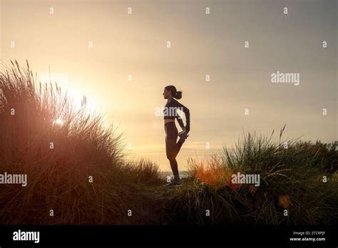 Sporty Woman Stretching Her Legs Doing Standing Quadricep Front Thigh Stretch Outdoors At