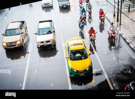 Cars Vans Buses And Motorbikes All Pass Along A Busy Intersection On