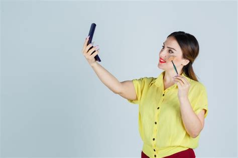 표현력 있는 젊은 여성이 스튜디오에서 포즈를 취하고 있습니다 무료 사진