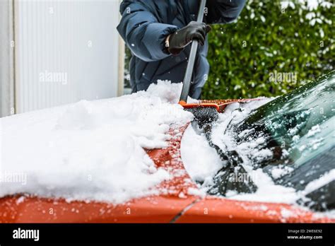 Cleaning Snow From Windshield Cleaning And Clearing The Car From Snow On A Winter Day Stock