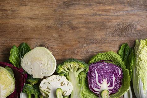 Different Whole And Cut Types Of Cabbage On Wooden Table Flat Lay Space For Text Stock Image