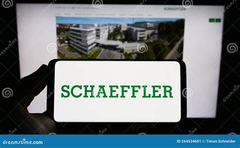 Person Holding Smartphone With Logo Of Company Schaeffler Technologies