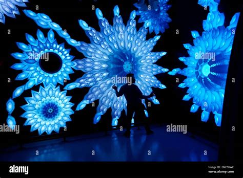 A Man Dances In Front Of A Light Installation At Omega Mart An