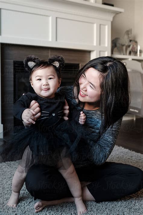 Asian Mother And Daughter Dressing Up During Halloween By Stocksy
