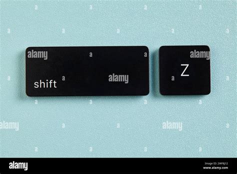 Shift Key And Z Key Detached From Keyboard On Blue Background Stock