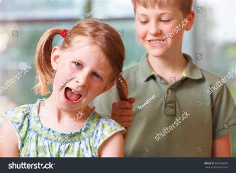 Boy Bullying Girl By Pulling Hair Stock Photo Shutterstock
