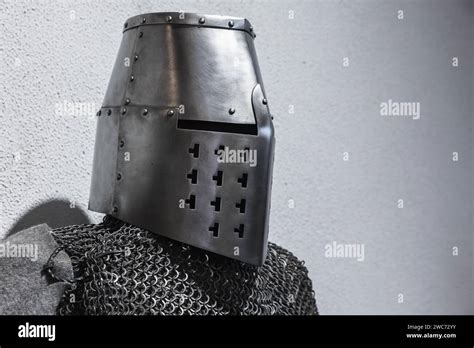Steel Armor Of A Medieval Crusader Knight Closed Iron Helmet And Chain Mail Over Gray Wall