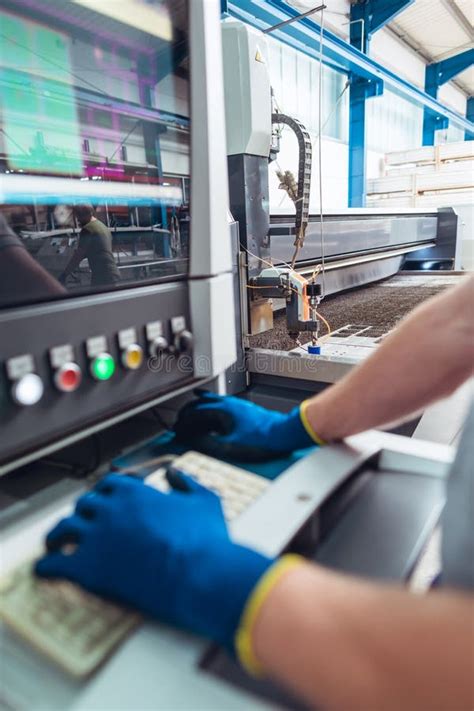 worker pressing buttons on cnc machine in factory stock image image