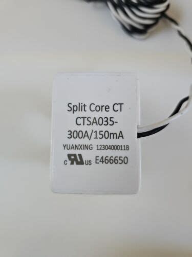 A White And Black Cord Connected To A Small Electronic Device With The