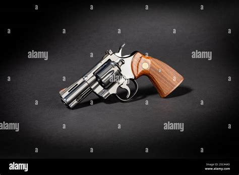 Studio Shot Of A Colt Python 3 Revolver Pistol Short Weapon On Black Background With Striking Studio Shot Of A Colt Python 3 Revolver Pistol Short Weapon On Black Background With Striking