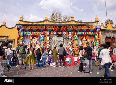 On The Eve Of Día De Los Muertos People Gather At Frida Kahlos Vibrant Ofrenda In Jardín Plaza