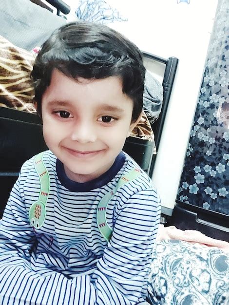 Premium Photo Portrait Of Cute Girl Sitting At Home