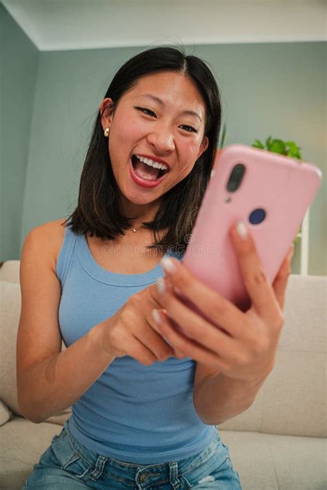 Vertical Young Asian Woman Having Fun Browsing On Internet With A