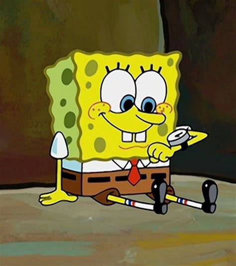 The Spongebob Character Is Sitting On Top Of A Piece Of Luggage And Pointing At Something