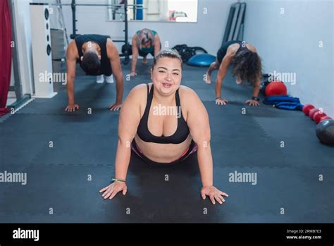 A Young Overweight Girl Happily Participates In A Stretching Class In Preparation For A Class