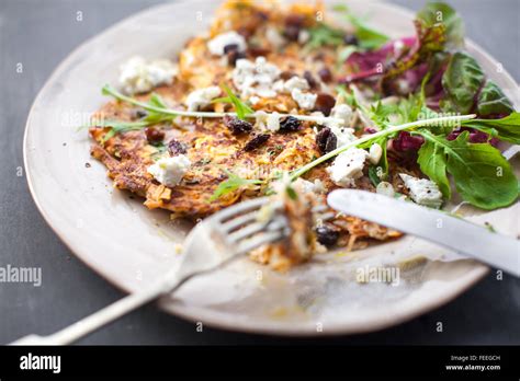 Carrot Parsnip Chili And Coriander Rosti With Organic Salad Goats Cheese Sultanas And Flaked