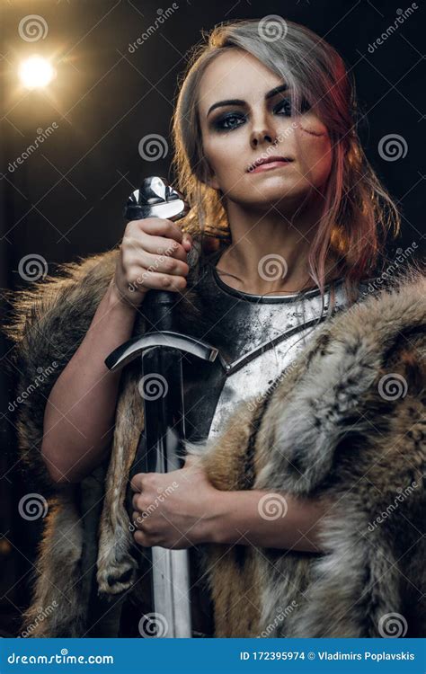 Portrait Of A Beautiful Warrior Woman Holding A Sword Wearing Steel
