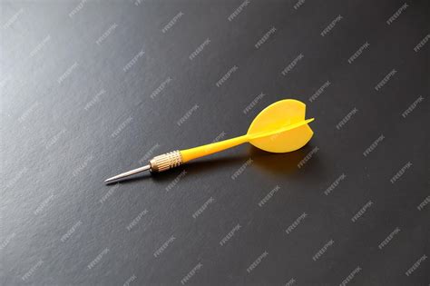 Premium Photo Yellow Dart Arrow On Black Background