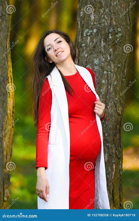 Pregnant White Woman Scientist Holding A Red Danger Triangle Warning