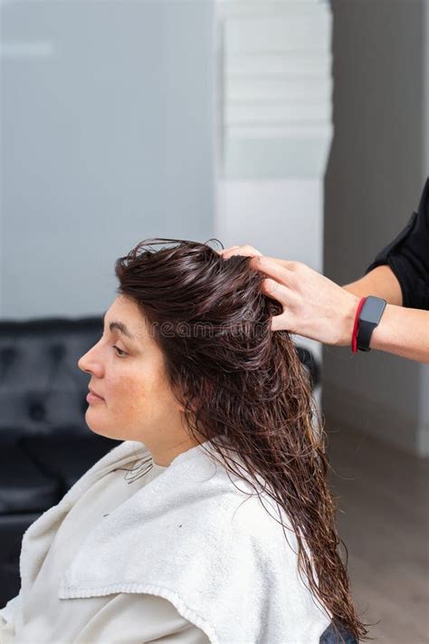 Hairstylist Massages Head And Scalp For A Young Female Client Stock
