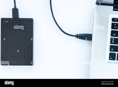 Black Ssd Hard Drive With Cable Connected To A Laptop With White Background Stock Photo Alamy