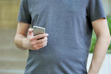 Premium Photo Man Holding Smart Mobile Phone Outdoors