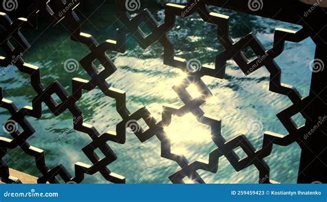 Through A Beautiful Openwork Lattice You Can See Sunbeams On The Water