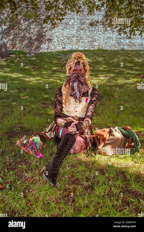 A Strange Looking Female Steampunk Sitting On Grass She Has An Octopus