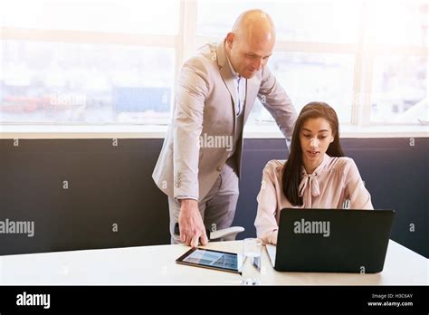 Businesswoman Being Supervised By Her Male Superior While Working Stock Photo Alamy