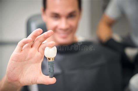 Client Of Aesthetic Dentistry Holding Enlarged 3d Model Of Dental