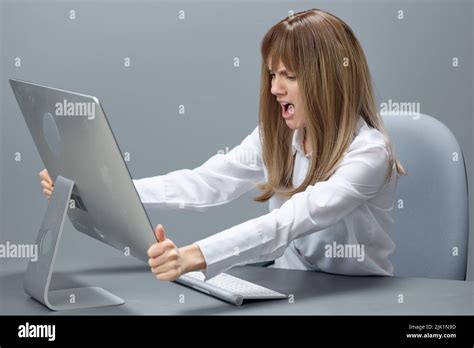 Angry Evil Pretty Blonde Businesswoman Screaming To Desktop Raging After Computer Software Crash