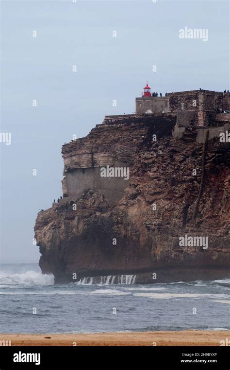 Lighthouse Farol De Nazare On Top Of The Cliff Nazare Portugal Stock