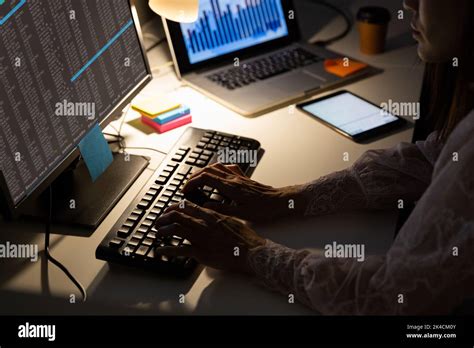 Hands Of Biracial Female Programmer Sitting At Desk Using Computer With Coding On Screen