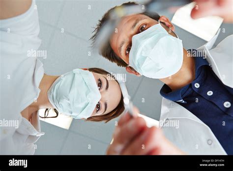 Patient Pov Of Dentist And Dental Assistant During Dental Treatment