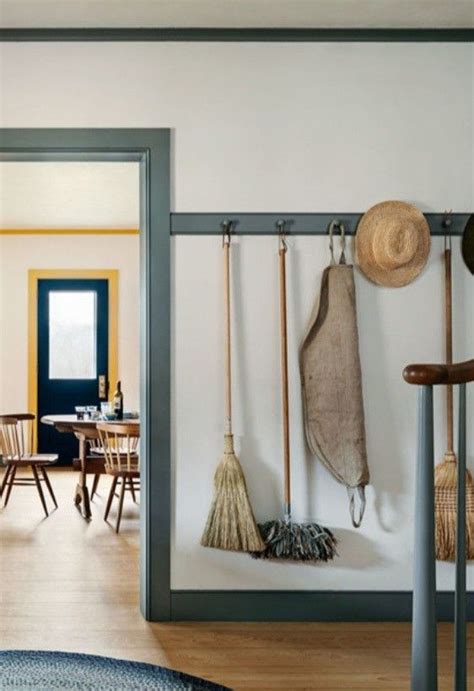 Entryway Decor With Hanging Brooms And Hats Shaker Style Decorating