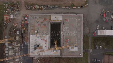 Top Down Ascending Shot Of Building Under Construction Revealing Pair Of Tower Cranes And
