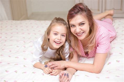 Mutter Und Tochter Die Zusammen Auf Einem Bett Spielen Stockbild