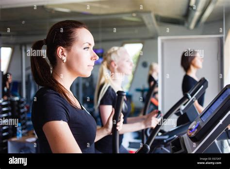 Three Girls Running On Treadmills Stock Photo Alamy